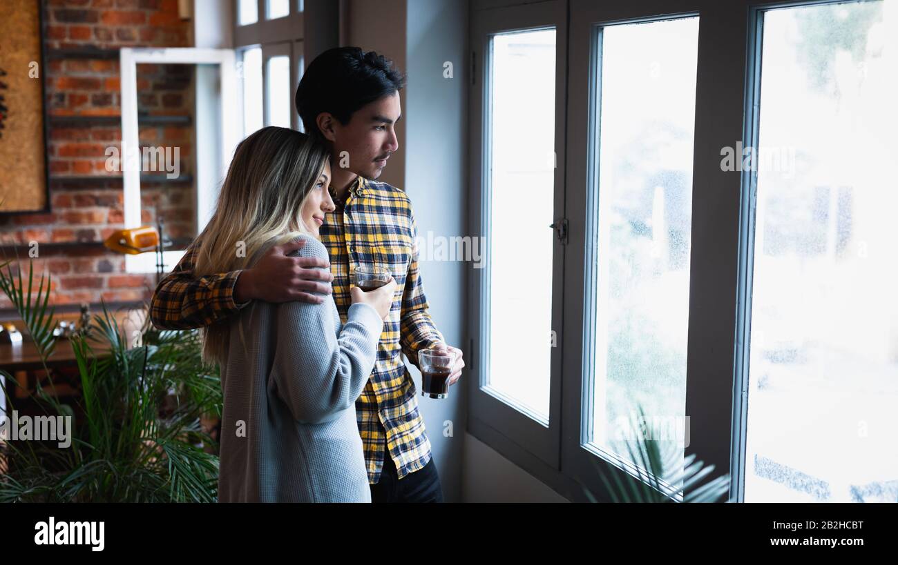 Young couple by window hi-res stock photography and images - Alamy