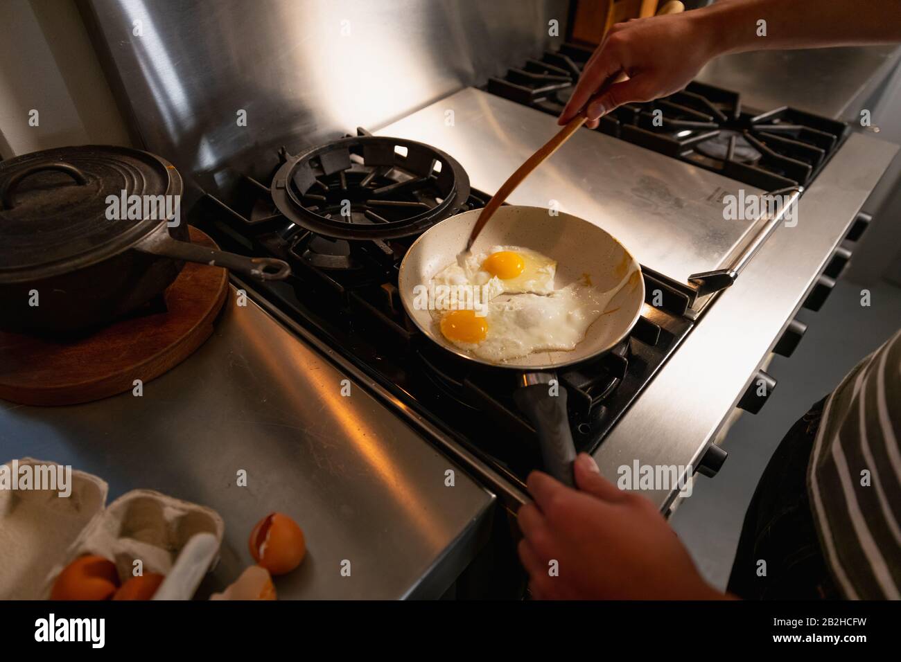 Cooking the fried eggs hi-res stock photography and images - Alamy