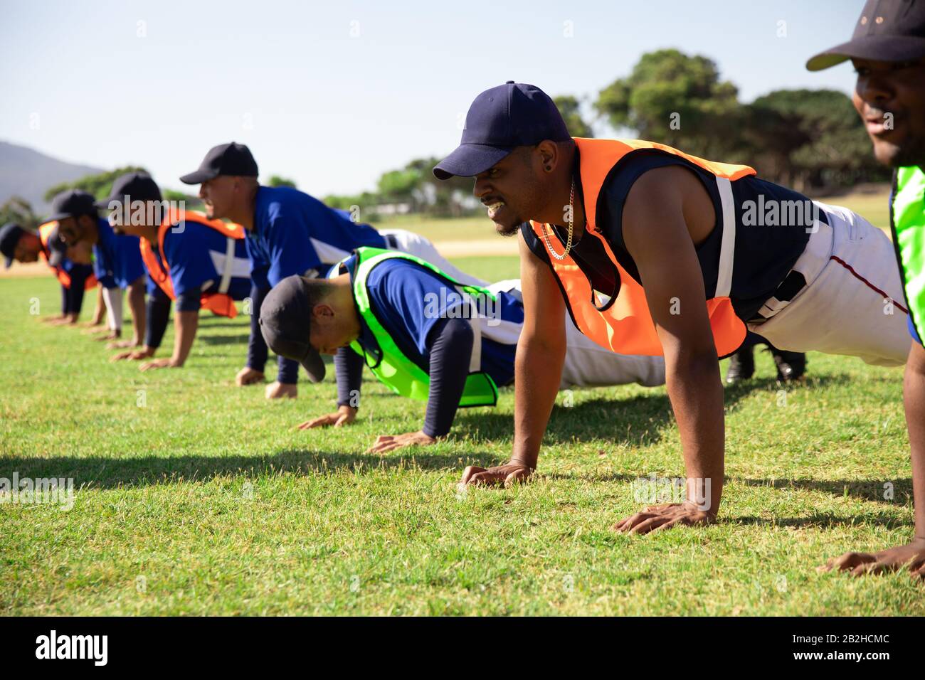 Baseball players making pushes up Stock Photo - Alamy