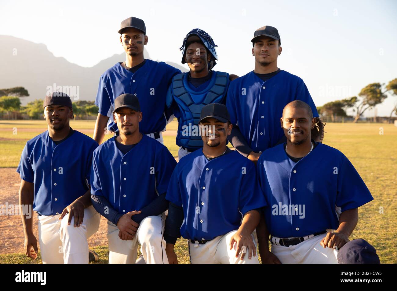 Baseball players standing on line and kneeling Stock Photo - Alamy