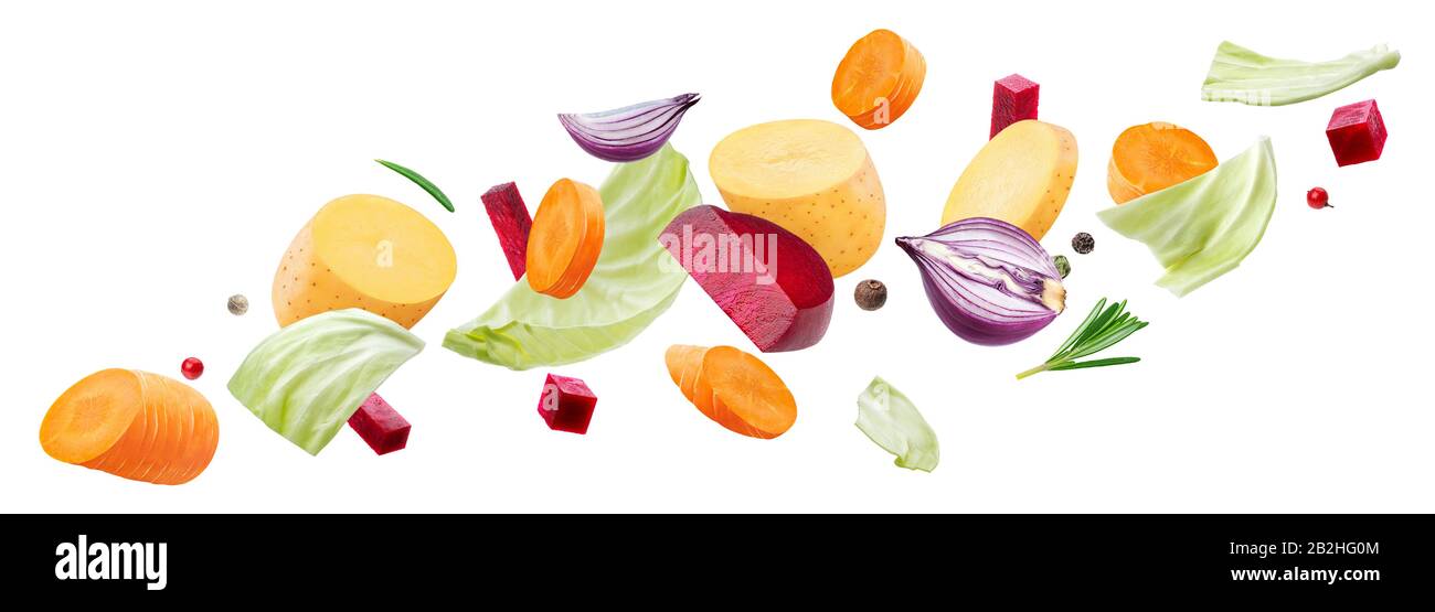 Falling pieces of different vegetables isolated on white background ...
