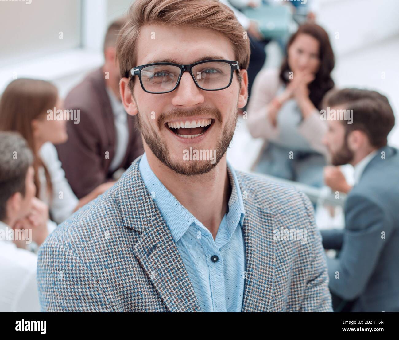 close up. smiling business man on the background of the office Stock ...