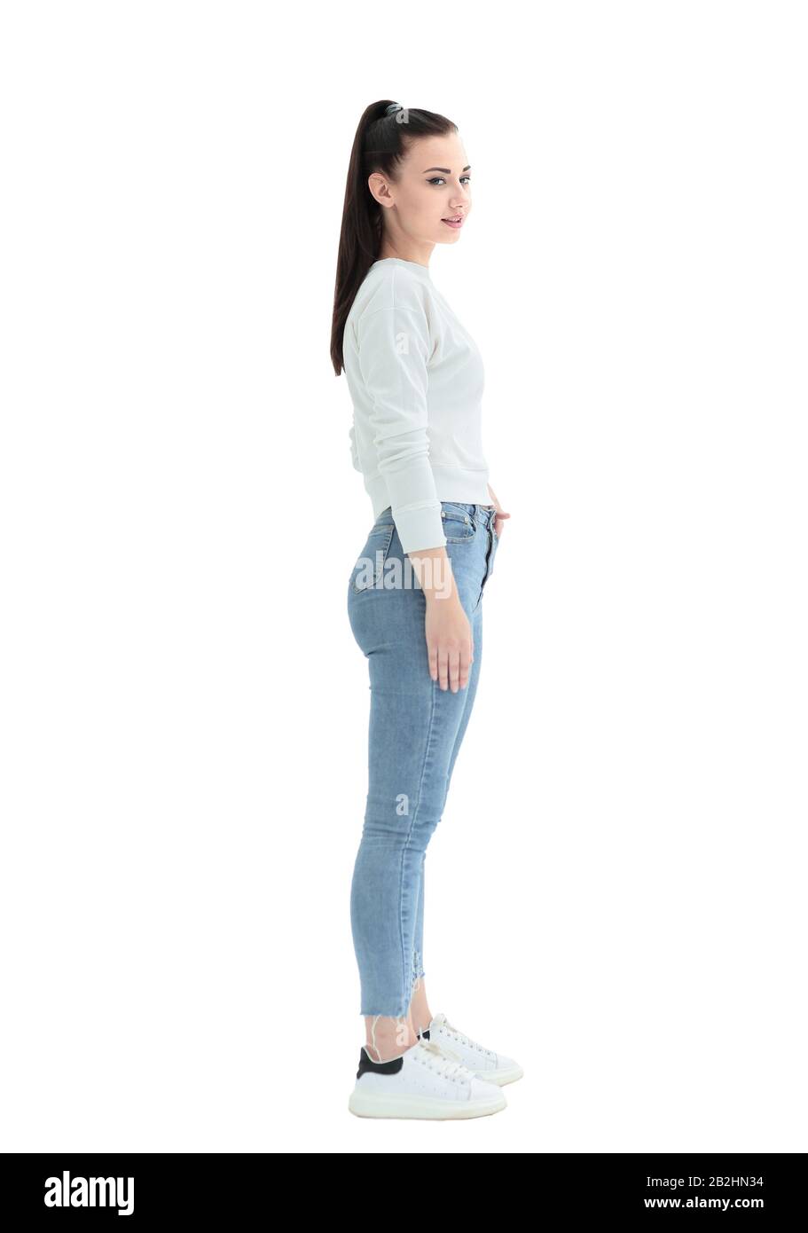 side view. stylish young woman in jeans and white blouse Stock Photo ...