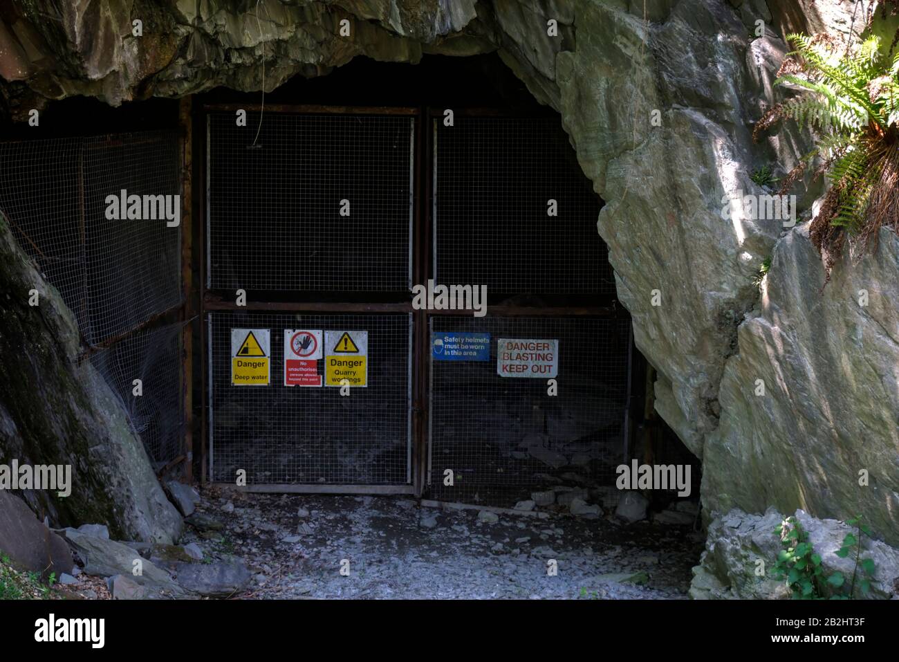 Quarry gates preventing entry to underground works with warning signage ...