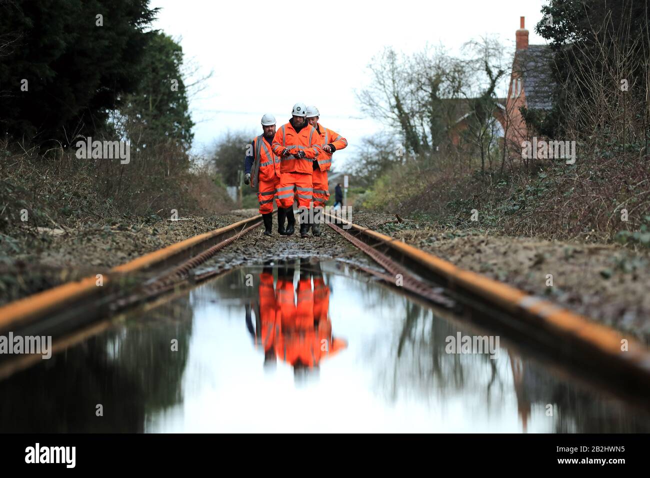 Network Rail employees walk up the flooded line near Snaith,Yorkshire ...