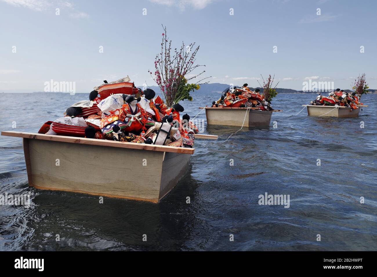 Boats carry hundreds of dolls from Awashima shrine in Wakayama on March ...