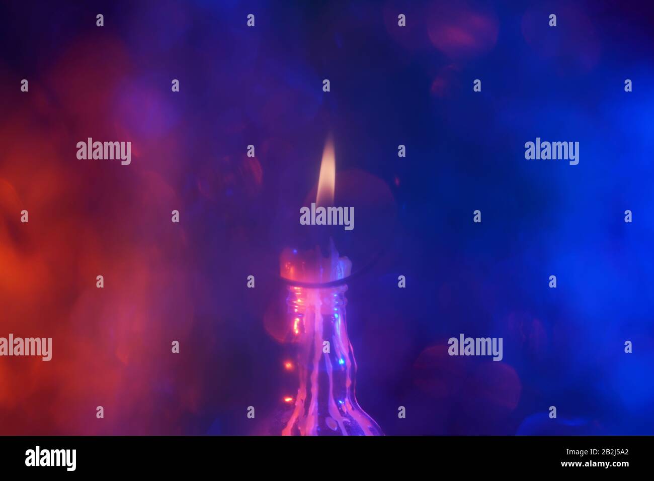 Candle after blowing out the flame photographed with colorful flashes ...