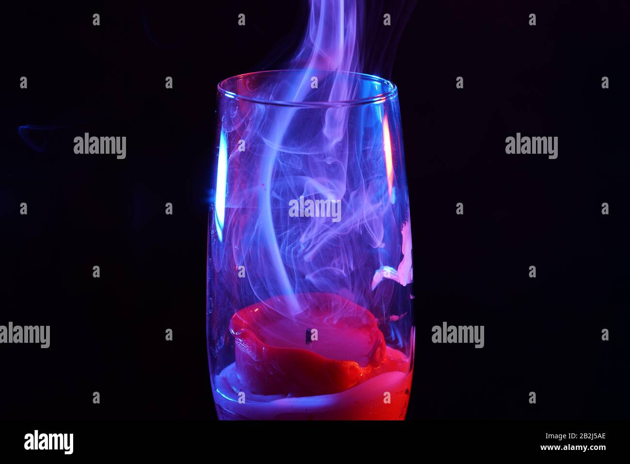 Candle after blowing out the flame photographed with colorful flashes ...
