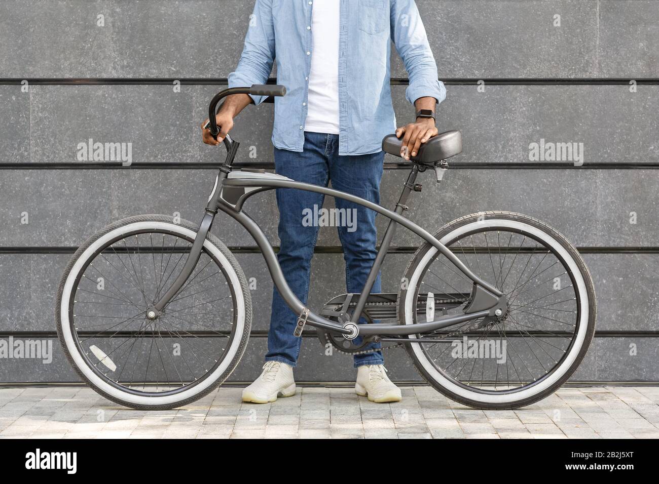 Black man standing bicycle hi-res stock photography and images - Alamy