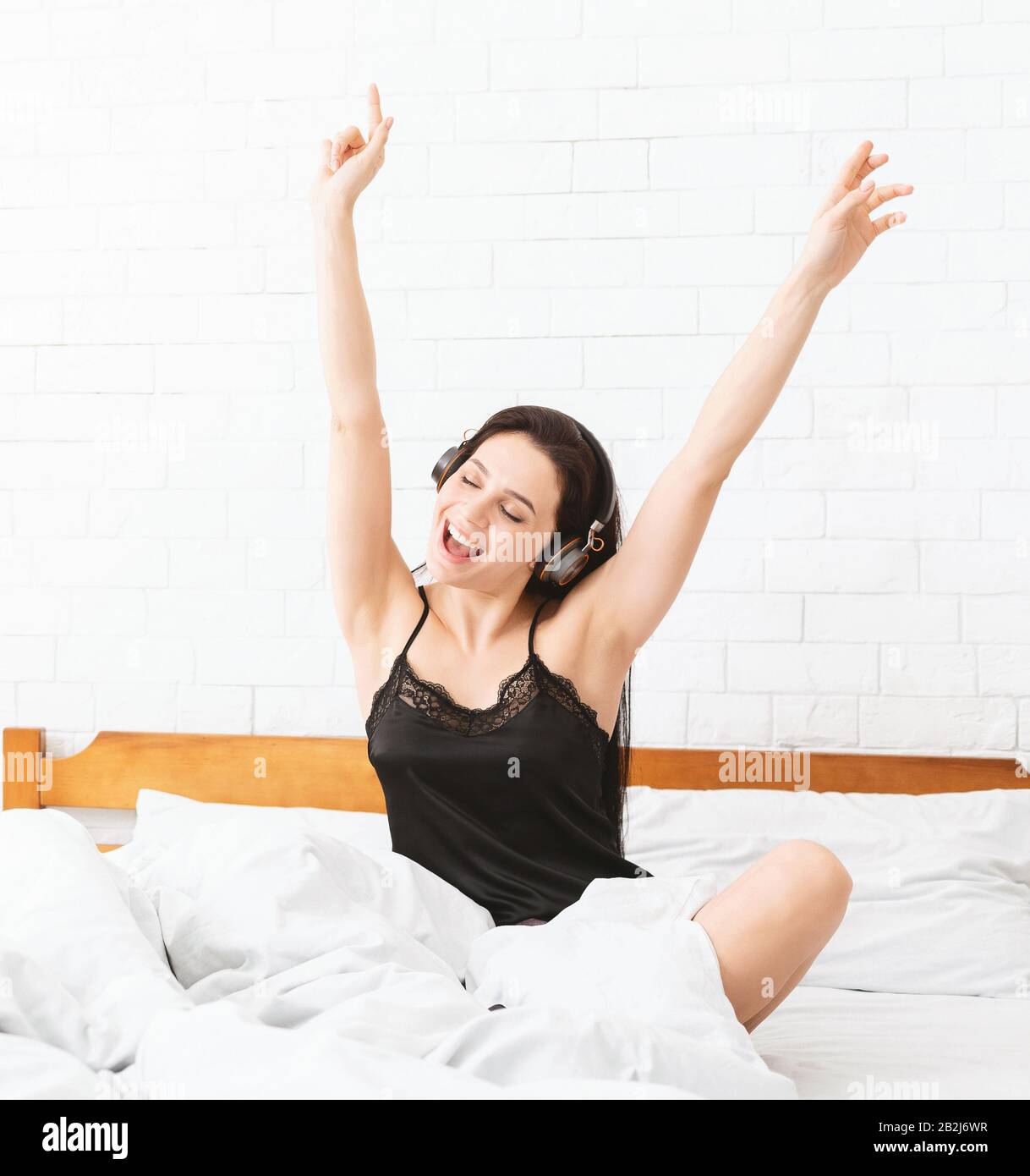 Active millennial girl dancing in bed in morning Stock Photo - Alamy