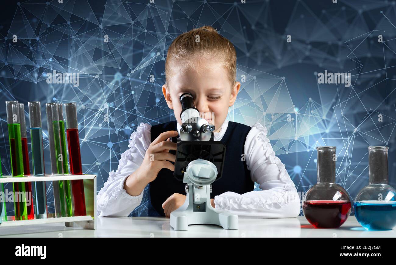 Little girl scientist looking through microscope Stock Photo - Alamy