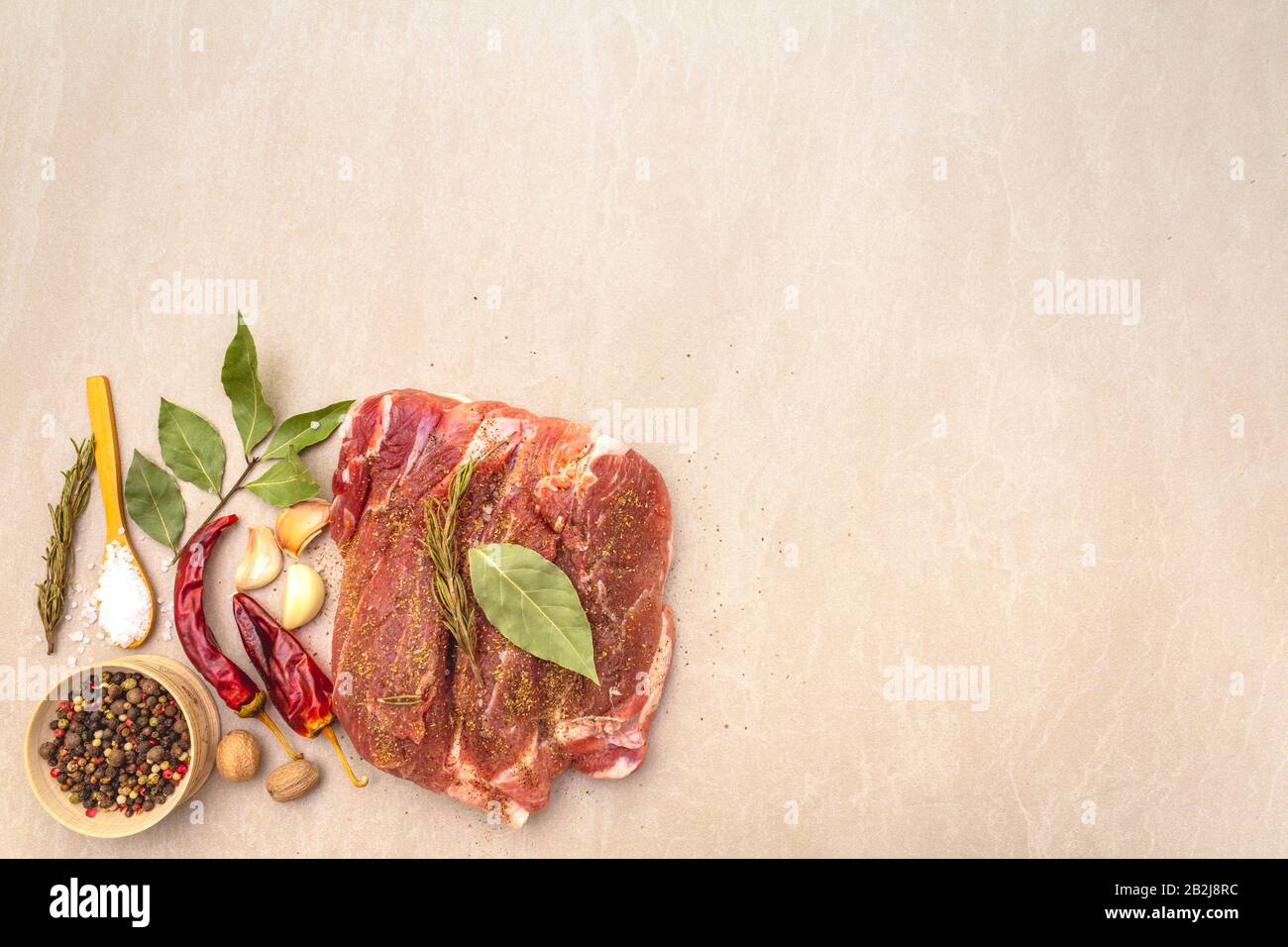 Raw pork shoulder. Spices, dry herbs, garlic, rosemary, bay leaf, hot ...