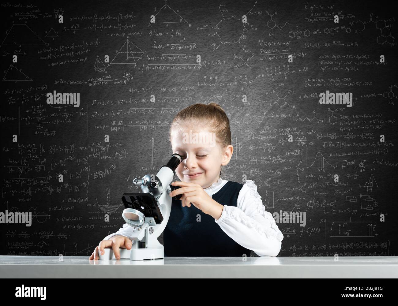 Little scientist looking through microscope Stock Photo - Alamy