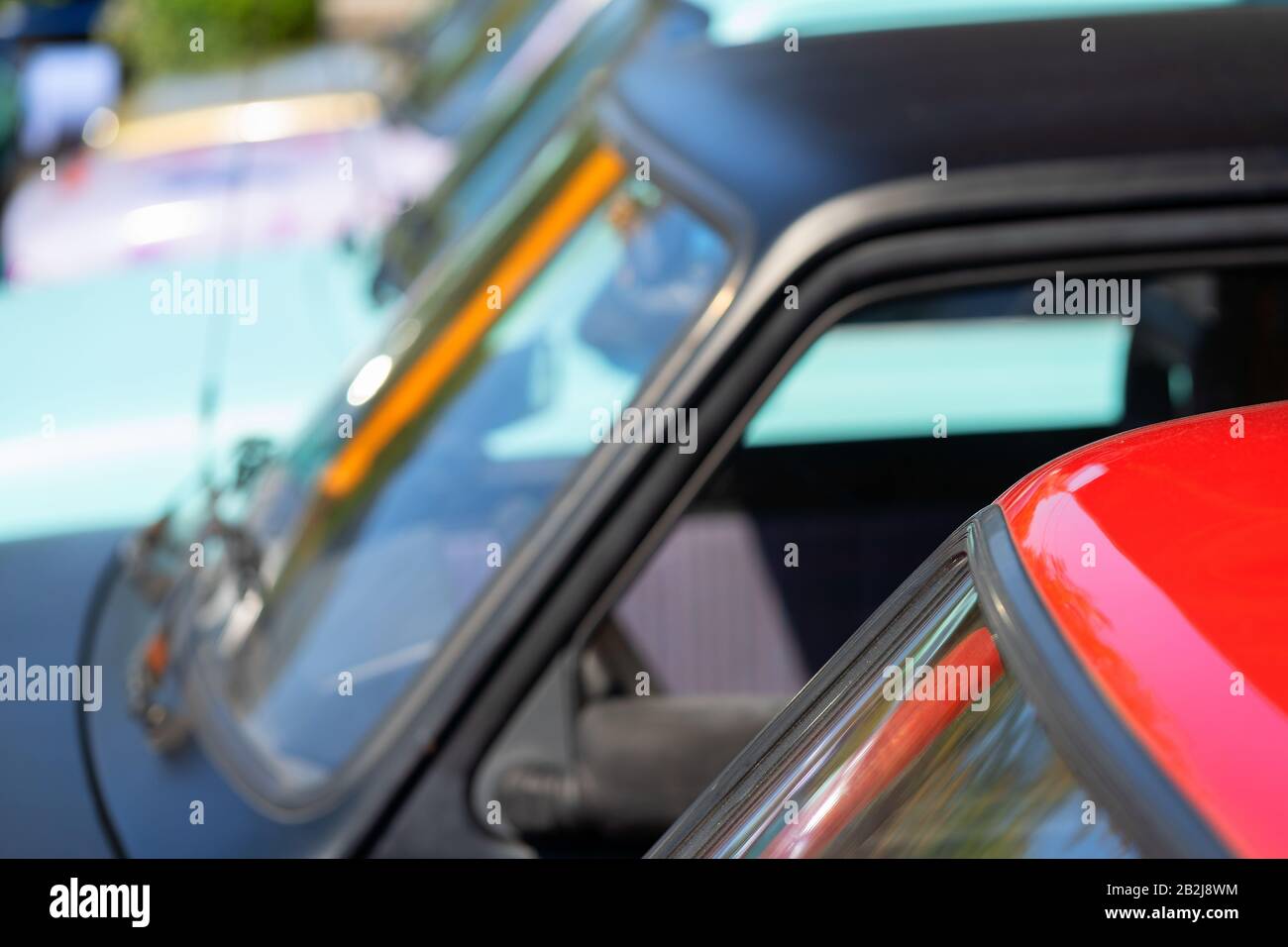 Two small cars of different colors on the road Stock Photo - Alamy
