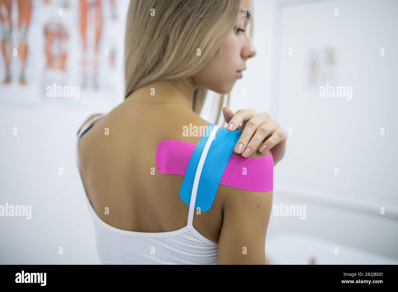 Black and white image of kinesiology taping treatment with blue tape on ...