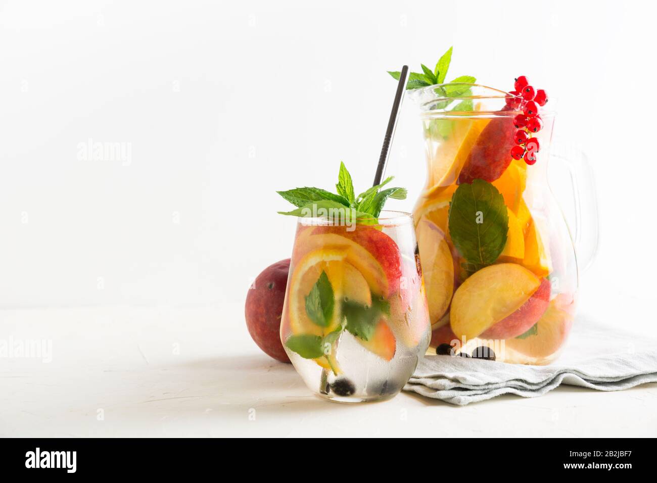 Freshness beverage with peach in glass garnish mint on light background ...