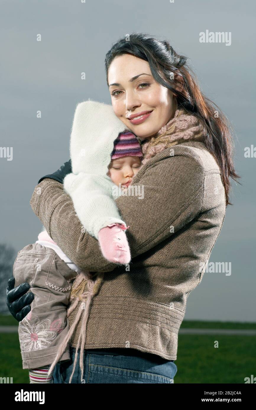 Mother hugging sleeping baby Stock Photo - Alamy