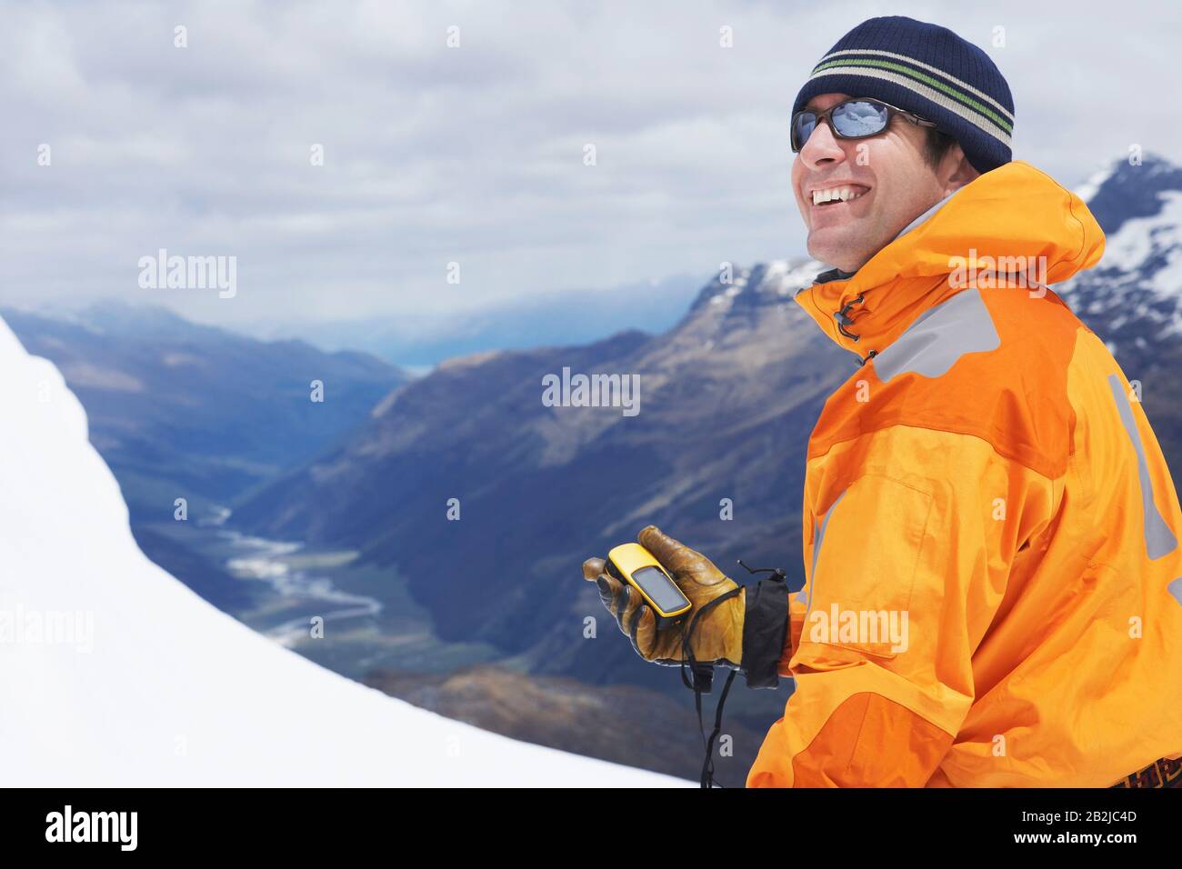 Mountain climber holding compass in snowy mountains Stock Photo - Alamy
