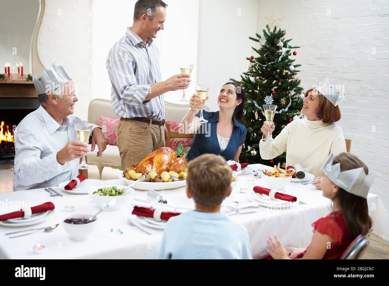 Family toasting at table at christmas dinner Stock Photo - Alamy
