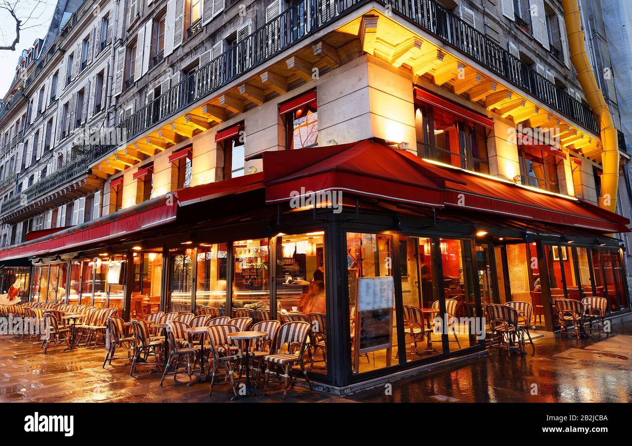 Traditional Parisian cafe in rainy evening, Paris Stock Photo - Alamy
