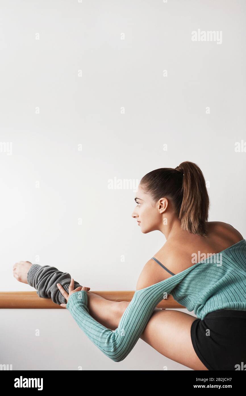 Ballet Dancer stretching at bar Stock Photo - Alamy