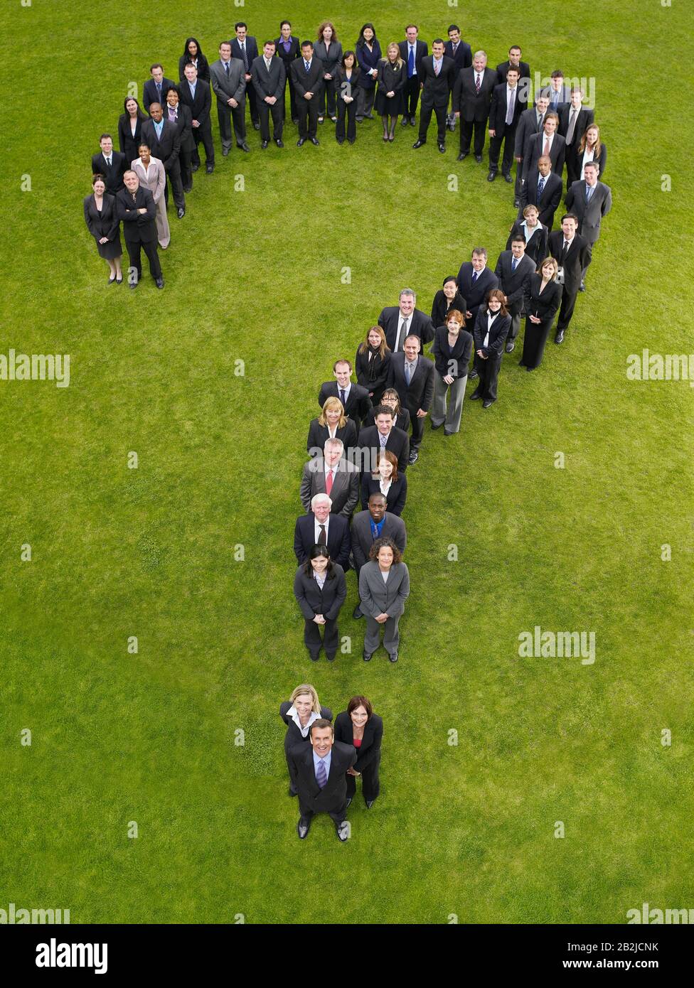 Large group of business people standing in question mark formation ...