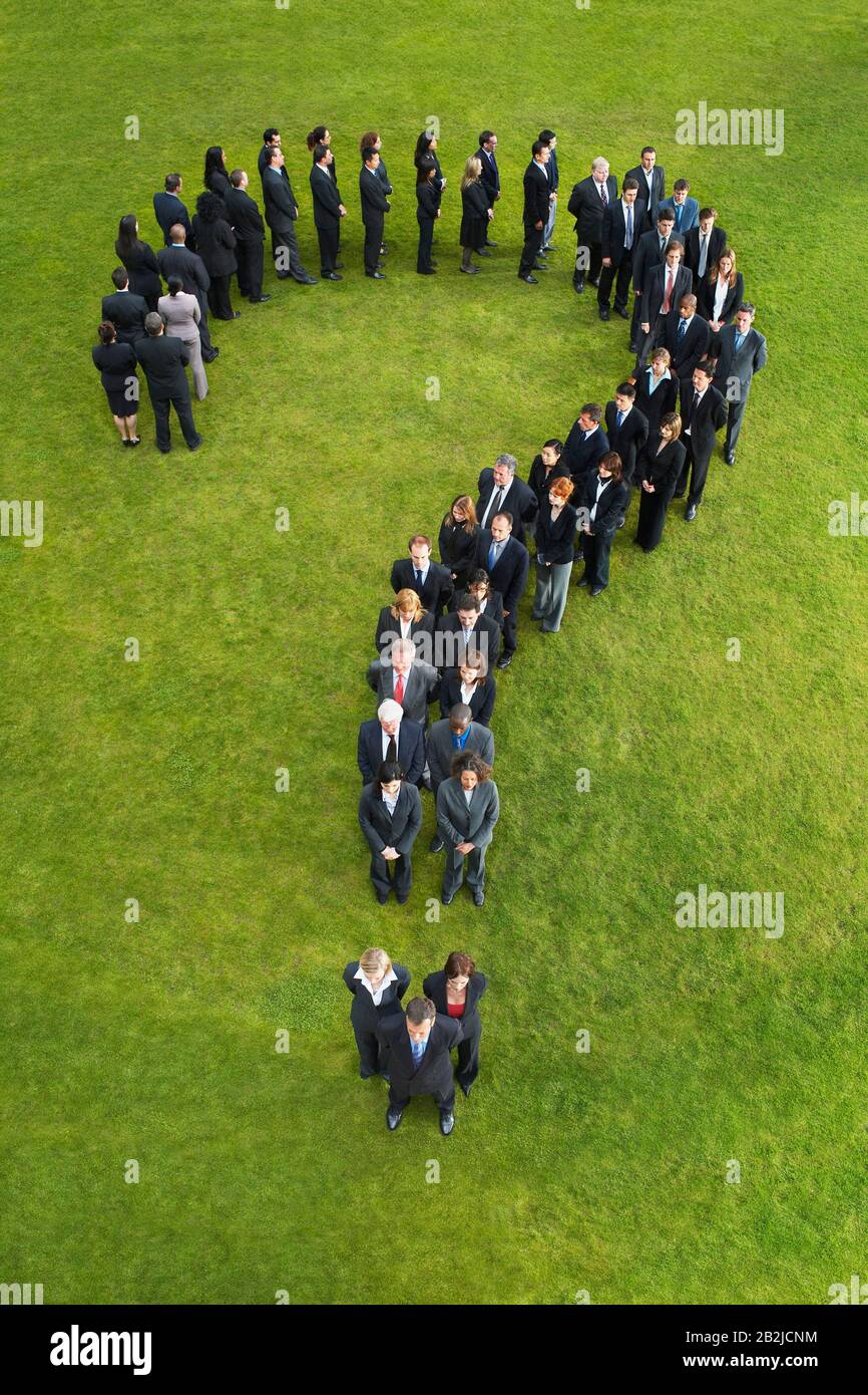 Large group of business people standing in question mark formation ...