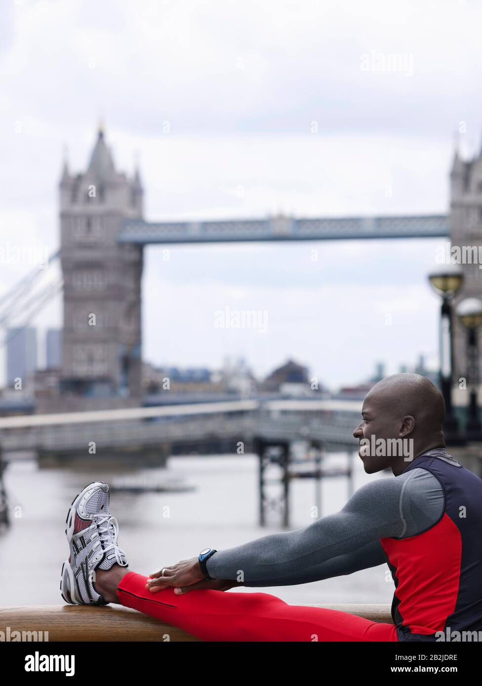 Man stretching in front of Tower Bridge England London Stock Photo - Alamy