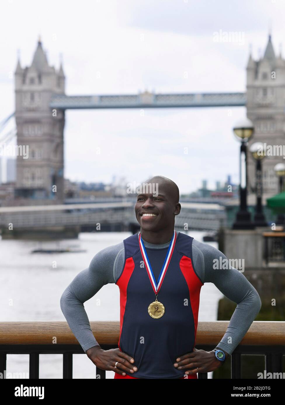 Man standing in front of Tower Bridge wearing medal England London ...