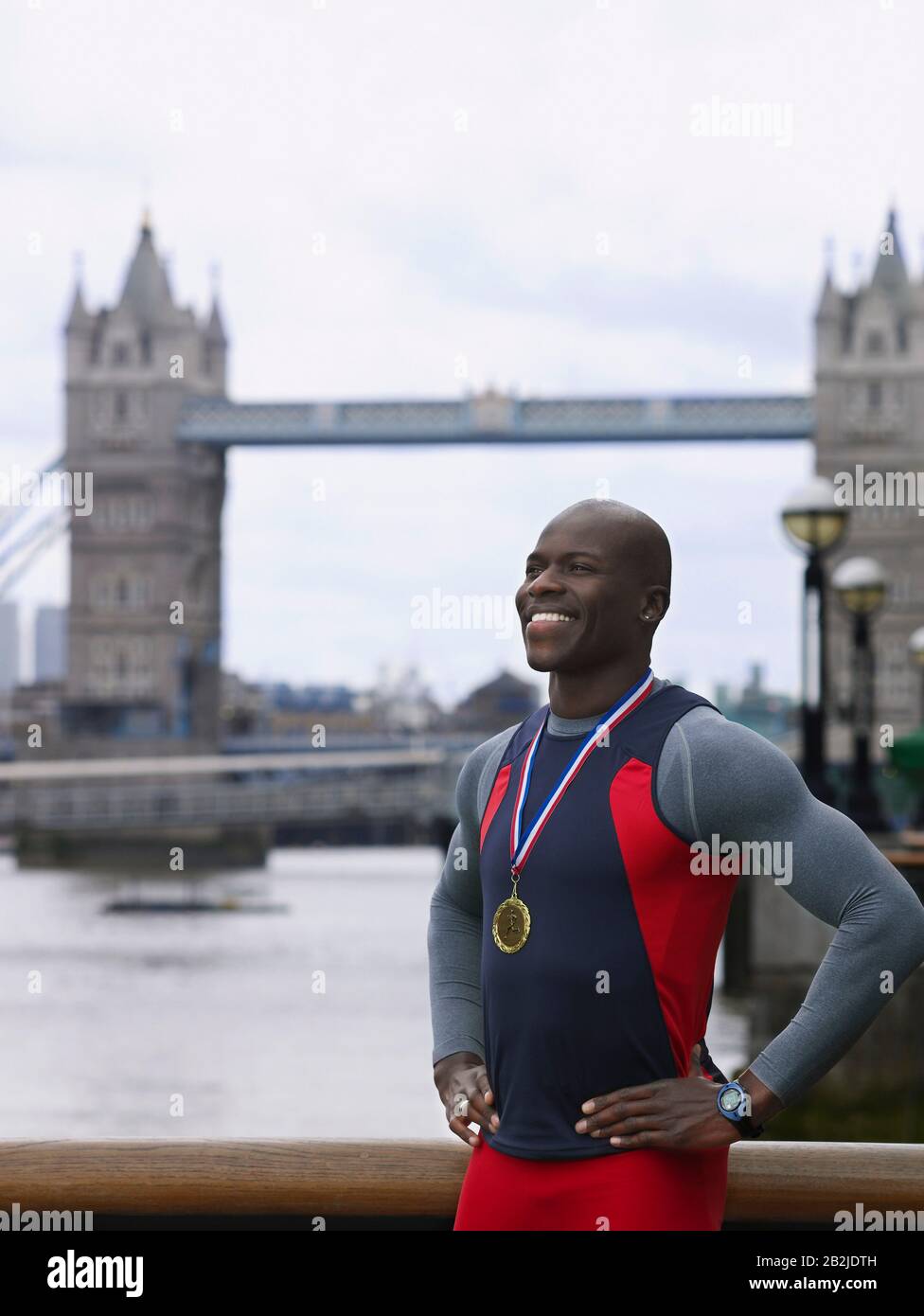 Man standing in front of Tower Bridge wearing medal England London ...