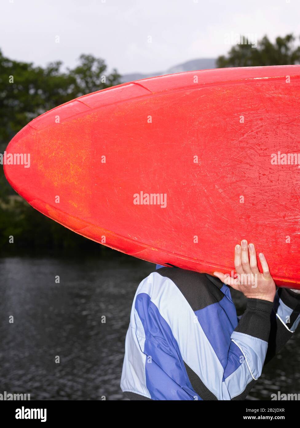 Man carrying kayak outdoors Stock Photo - Alamy