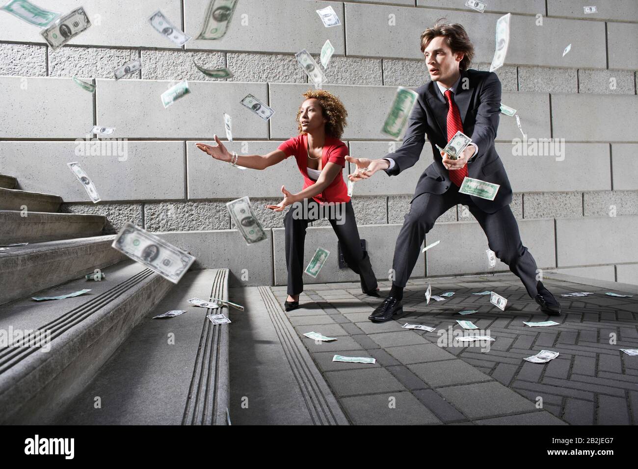 Woman catching money hi-res stock photography and images - Alamy