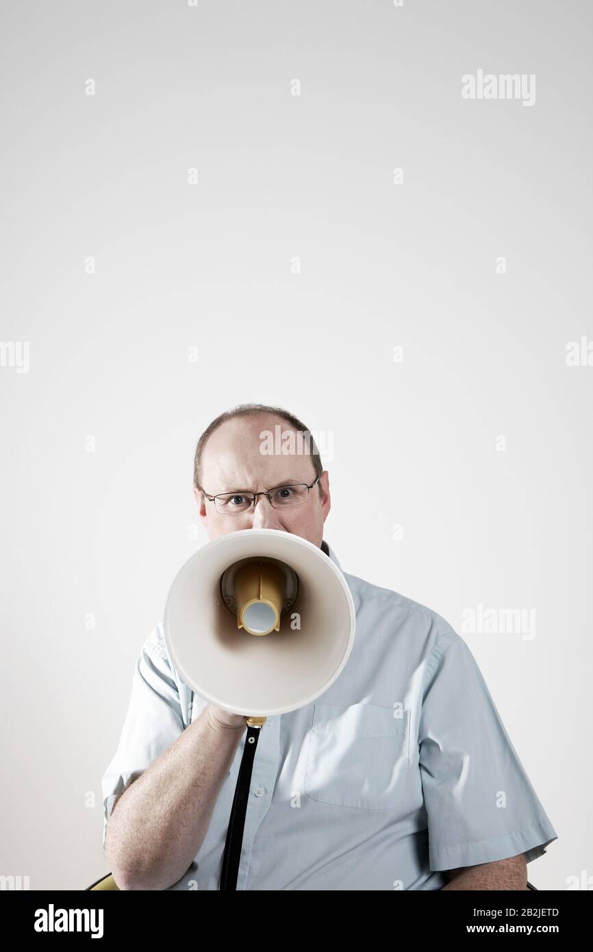 Man talking through megaphone Stock Photo - Alamy