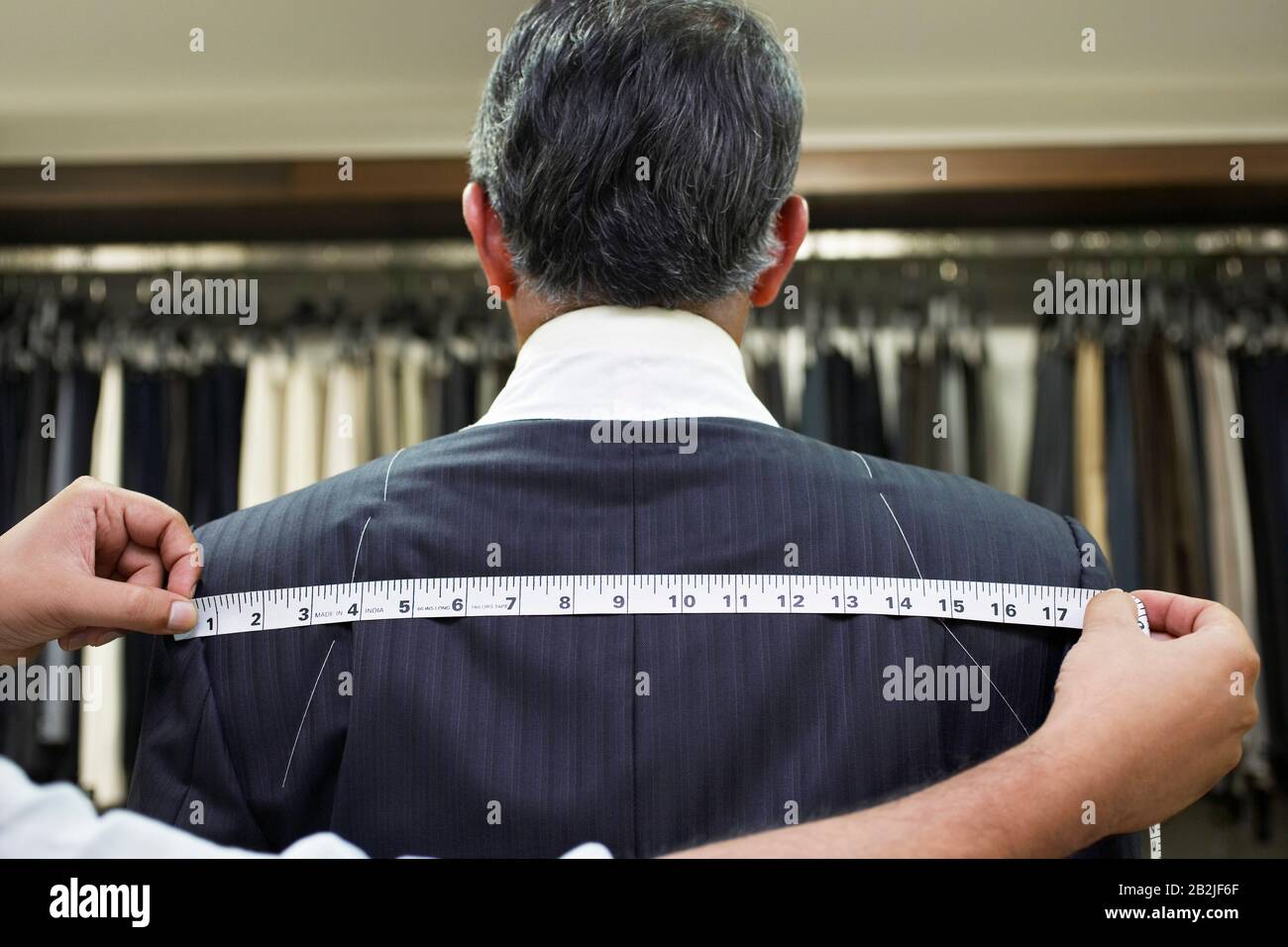 Tailor measuring business man for suit close up Stock Photo - Alamy