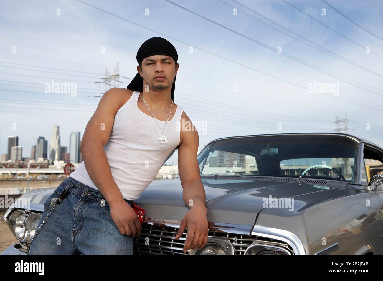 Portrait of man leaning on car Stock Photo - Alamy