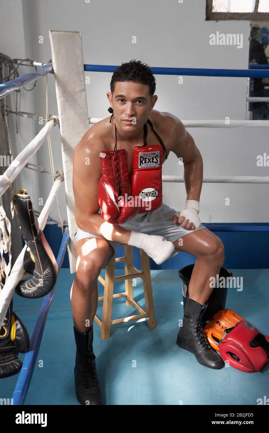 Man sitting in corner of boxing ring Stock Photo - Alamy