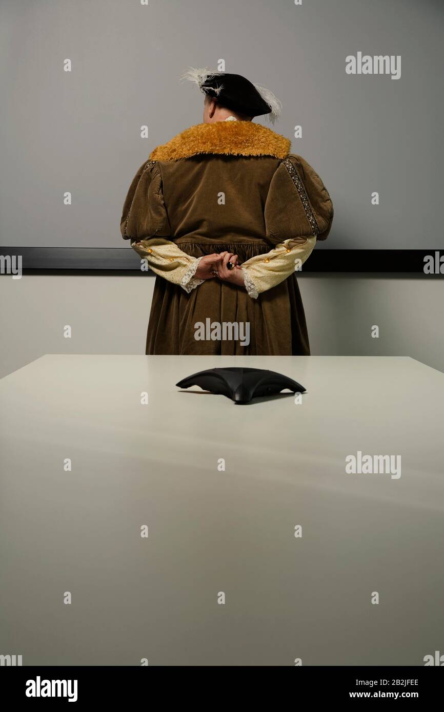 King Henry VIII standing behind table in conference room Stock Photo ...