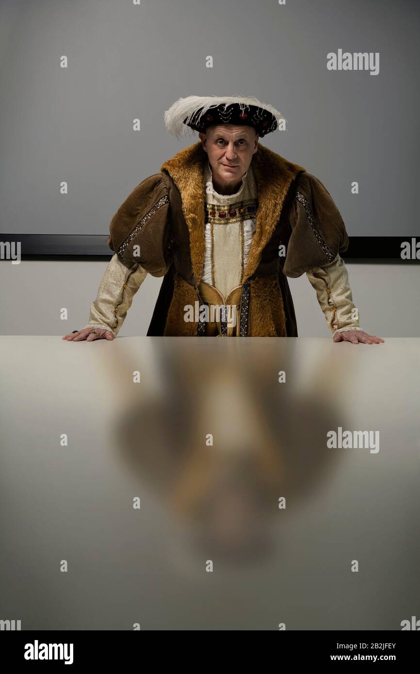 King Henry VIII standing at table in conference room Stock Photo - Alamy