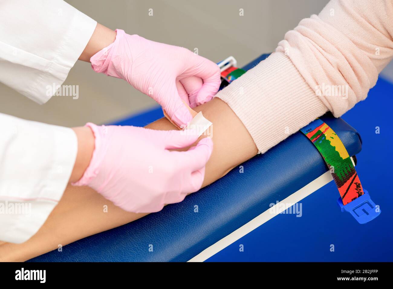 Nurse disinfecting arm skin by cotton before giving a injection vaccine ...