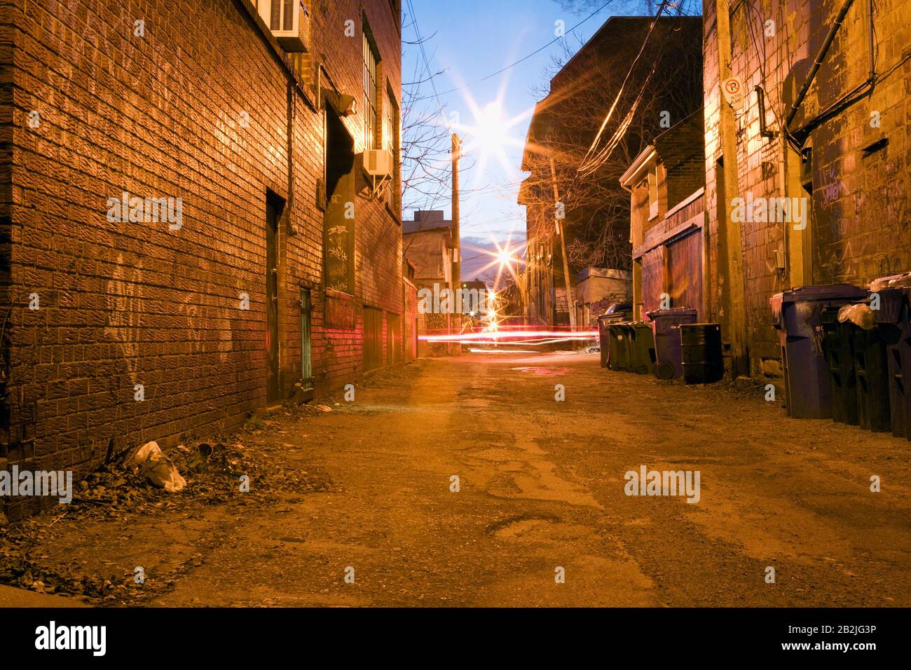 Car head lights in alleyway at dusk Stock Photo - Alamy