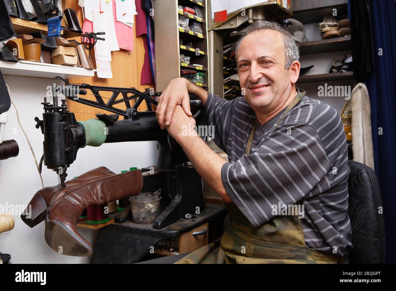 Shoemaker Repairing Boot in Shoe Shop Stock Photo - Alamy