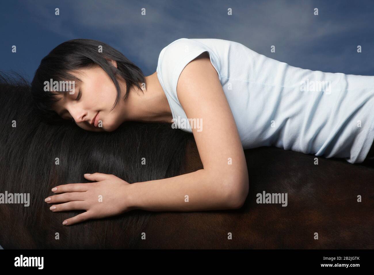 Equestrian Lying on Back of Horse Stock Photo - Alamy