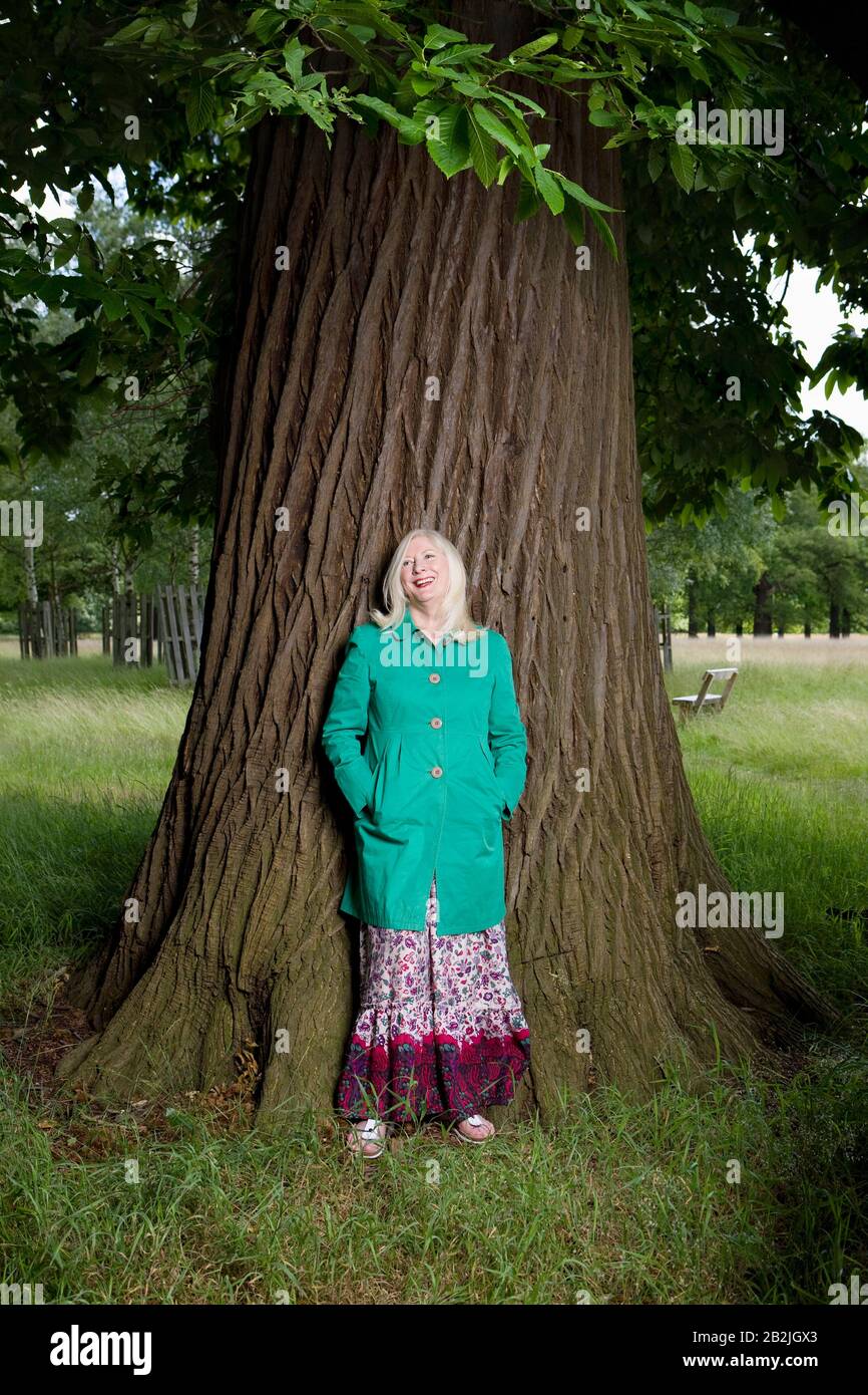 Woman Standing Beneath a Tree Stock Photo - Alamy