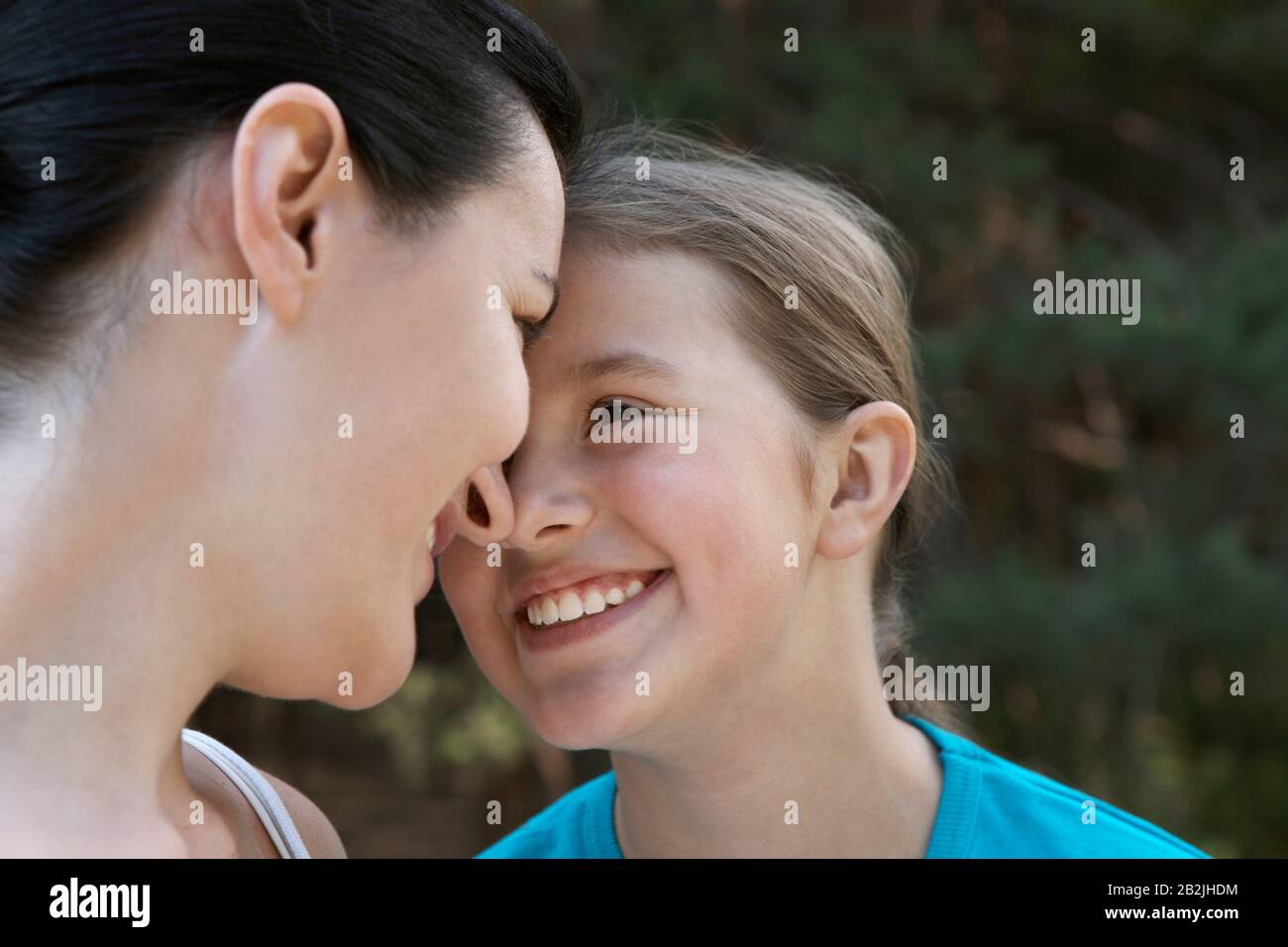 Mother looking into daughters eyes smiling close-up Stock Photo - Alamy
