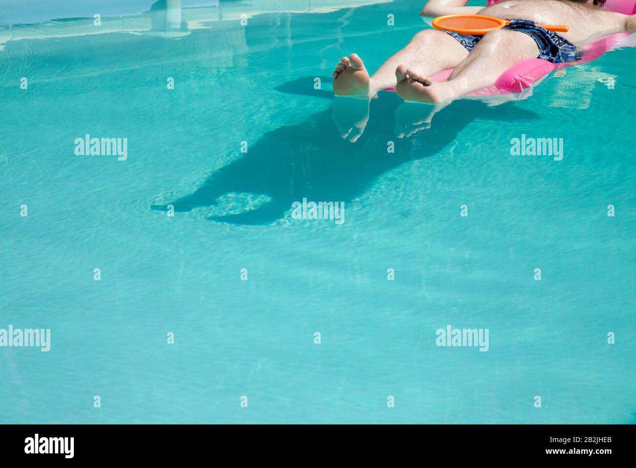 Person floating in pool Stock Photo - Alamy