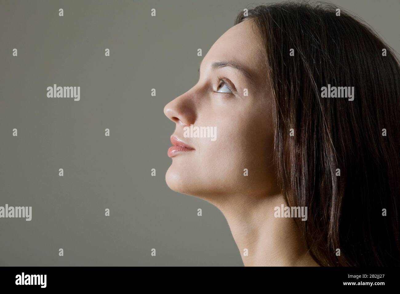 Profile Of Young Woman Looking Up Studio Shot Stock Photo - Alamy