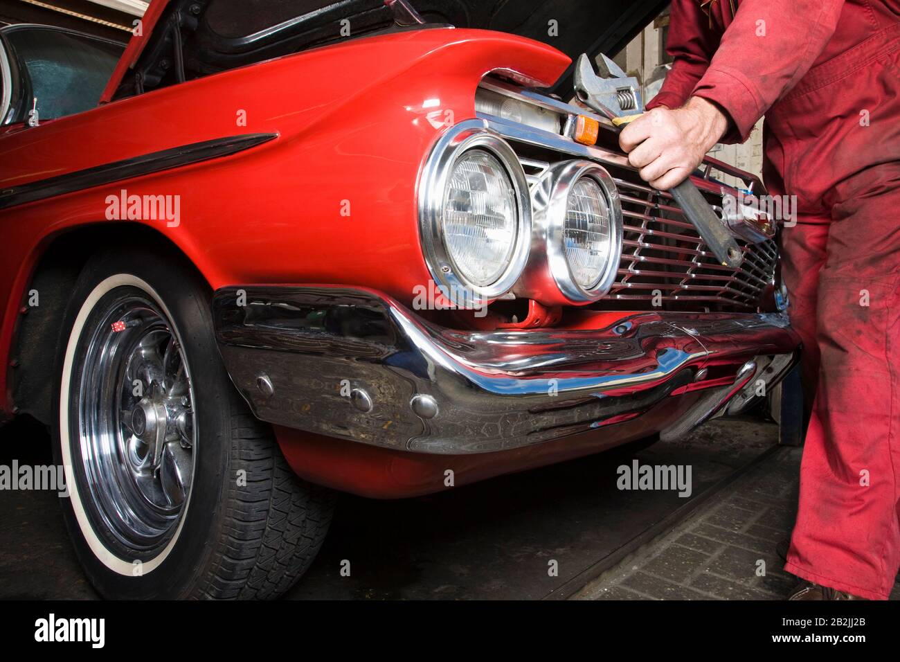 Mechanic Working on Engine of a Vintage Car Stock Photo - Alamy