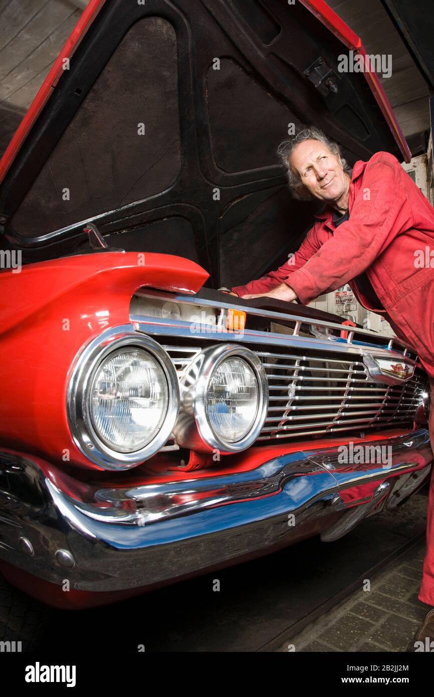 Mechanic Working on Engine of a Vintage Car Stock Photo - Alamy