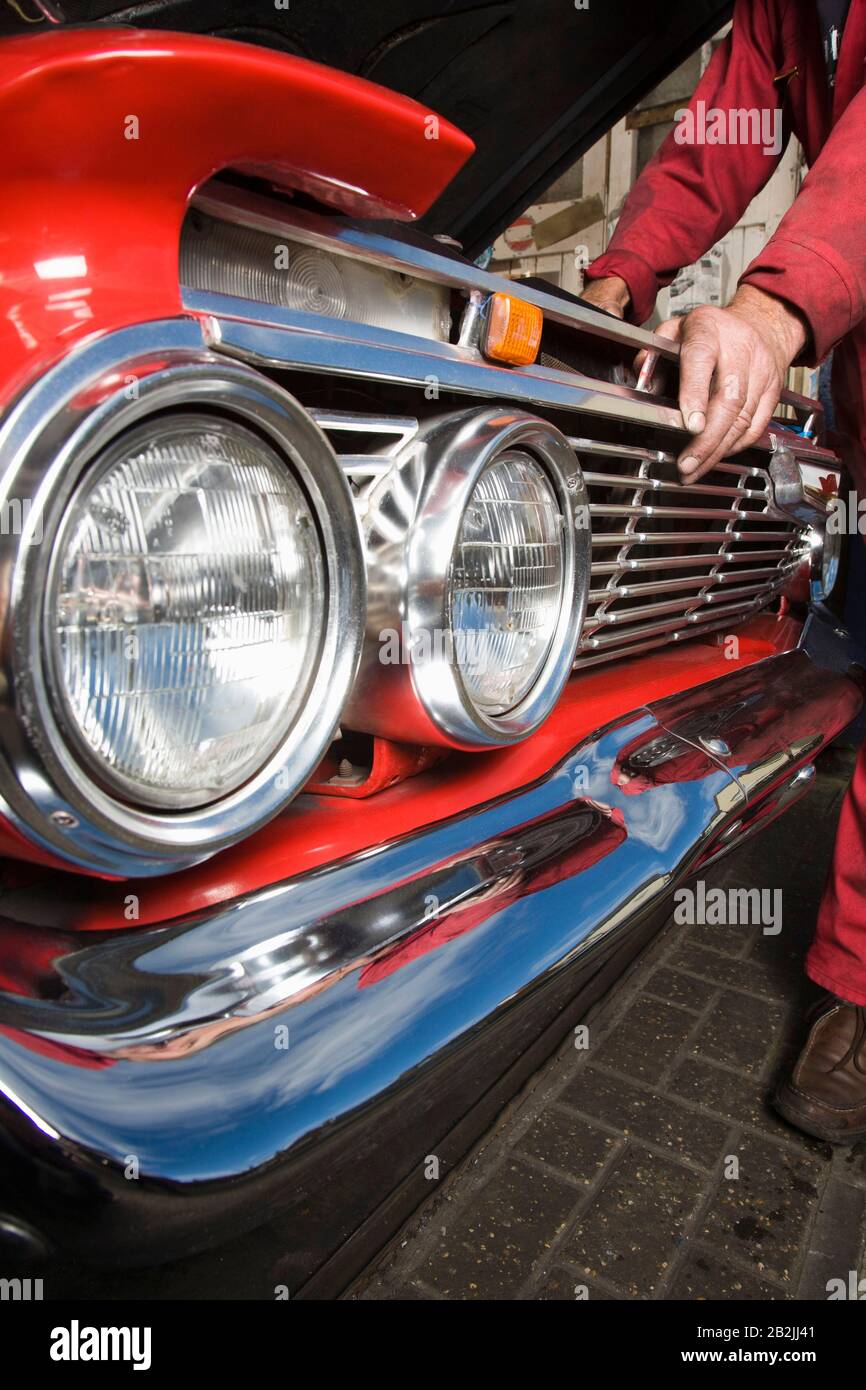 Mechanic Working on Engine of a Vintage Car Stock Photo - Alamy