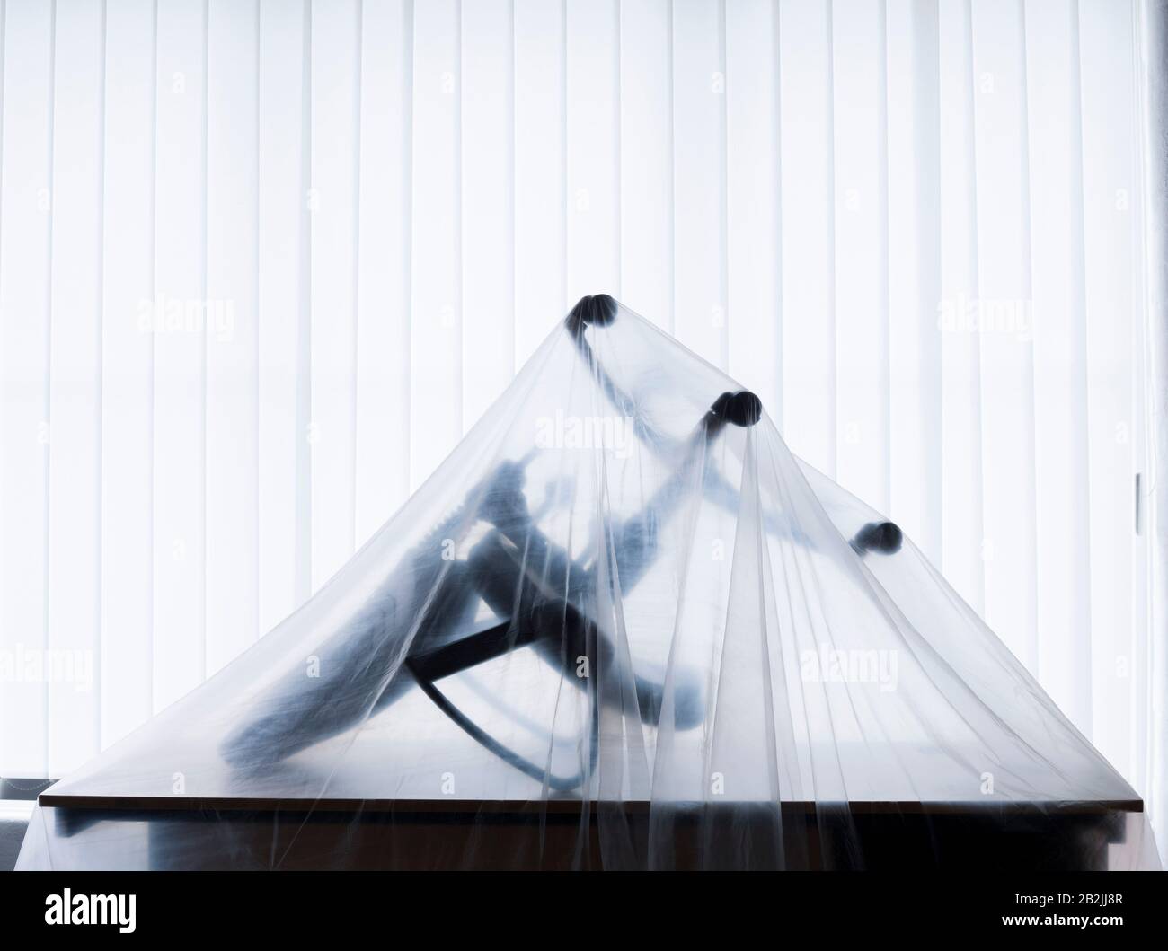 Office chair under curtain Stock Photo - Alamy